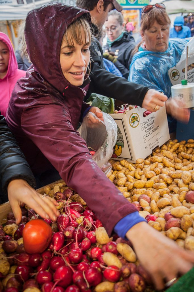 Woman reaching for Alaskan potato