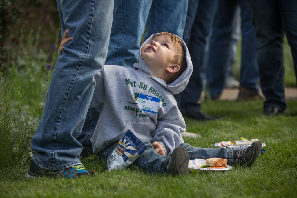 Little kid looking up at parent